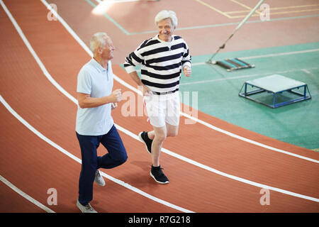 Sporty mature man running at stadium Stock Photo - Alamy