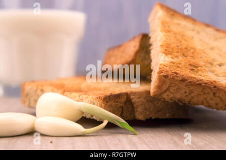 glass of milk and toasted bread on table Stock Photo - Alamy