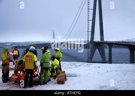 Narvik. 9th Dec, 2018. Chinese workers walk beneath the Halogaland ...