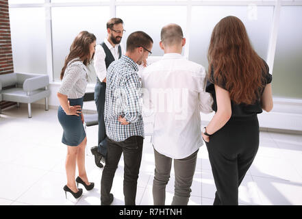 business team discusses their ideas standing in the hallway of the ...
