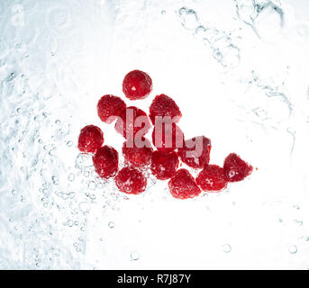 Raspberries with a splash of water Stock Photo - Alamy