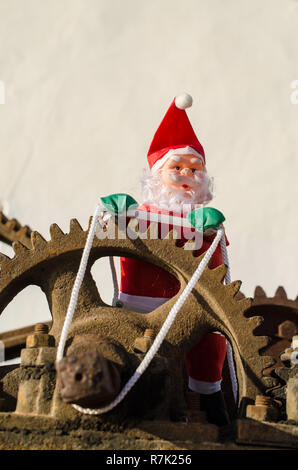 Santa in the cogwheels of consumerism, a concept Stock Photo - Alamy