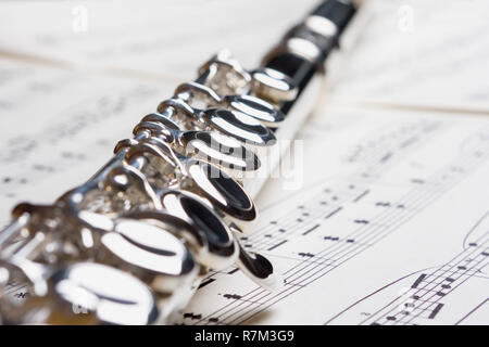 transverse flute on sheet music Stock Photo - Alamy