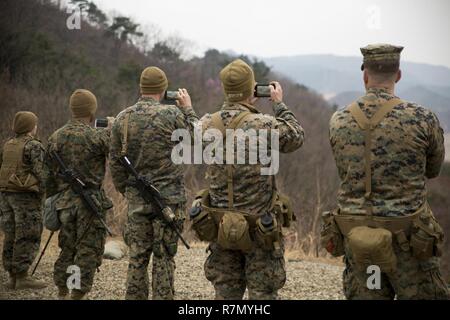 A U.S. Marine Corps M58 Mine Clearing Line Charge (MICLIC) fires a ...