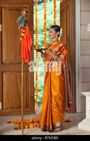Maharashtrian woman praying while holding a puja thali Stock Photo - Alamy