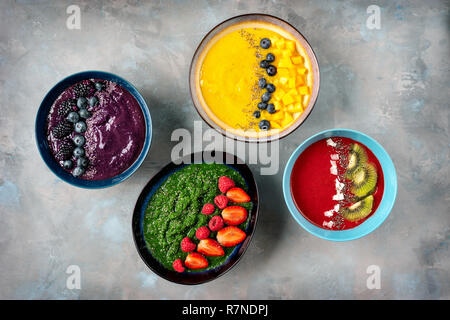 Many plates with colorful fruits smoothie seeing from above Stock Photo ...