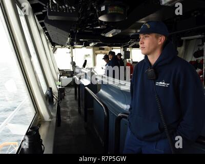 US Navy Crewmembers stand a force protection watch at one of the .50 ...