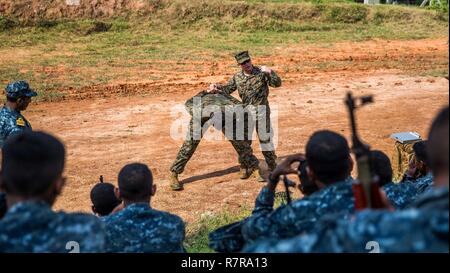 A US Marine demonstrates detainee handling with Gabonese soldiers and ...