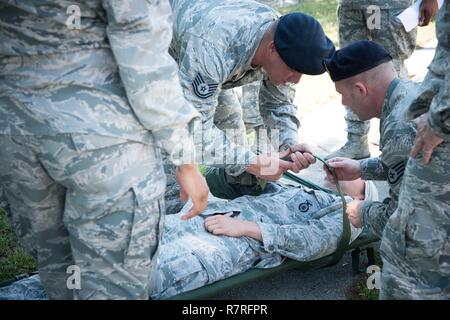 Members of the 403rd Security Forces Squadron practice a litter carry ...