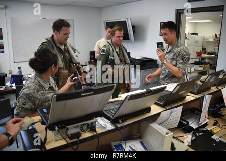 Members of the 144th Maintenance Operations Flight debrief 194th ...