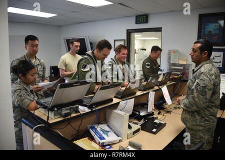 Members of the 144th Maintenance Operations Flight debrief 194th ...