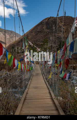 Suspension bridge with buddhist prayer flags on the Annapurna circuit ...