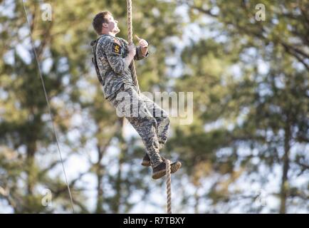 A U.S. Army Ranger climbs a rope as his teammate anchors it during the ...