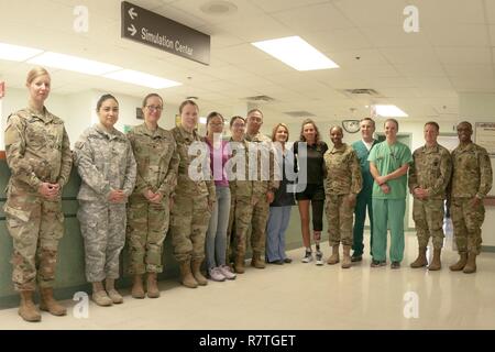 Capt. Kelly Elmlinger, an Army nurse and cancer survivor, displays her ...