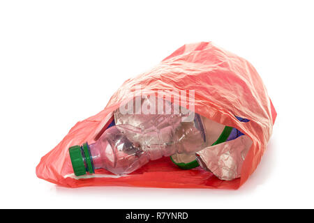 Red plastic garbage bag with stick out empty plastic bottle and other ...