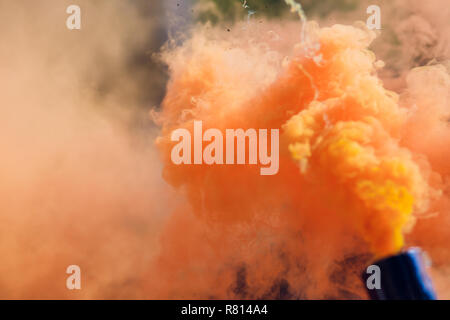 colorful orenge smoke bombs in action Stock Photo - Alamy