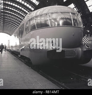 High speed white train on the railway station at sunset. Nuremberg ...