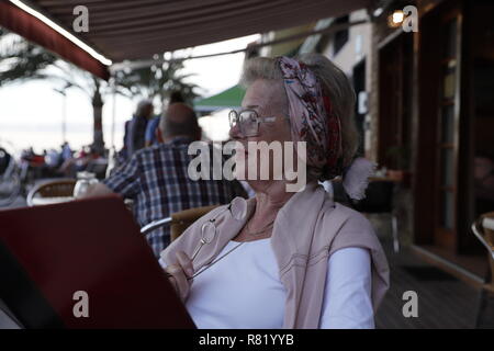 Attractive 78 year old woman during a summer restaurant visit ...