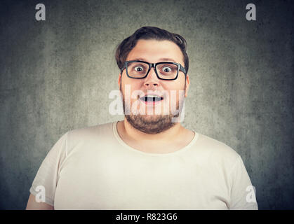 amazed overweight man with beard looking at camera isolated on green ...