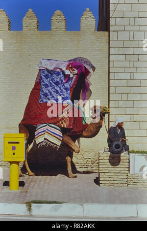 A camel with a howdah carriage outside the Great Mosque at Kairouan ...