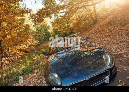 A black roofless car driving fast on the asphalt with a beautiful ...