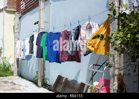 Hanging clothes under the sun, outside sun drying in the small ...