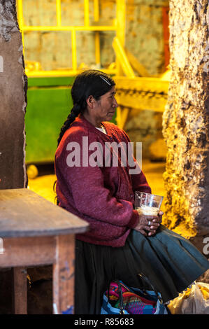 The woman is drinking chicha. Chicha- Inca beer is made from a special ...