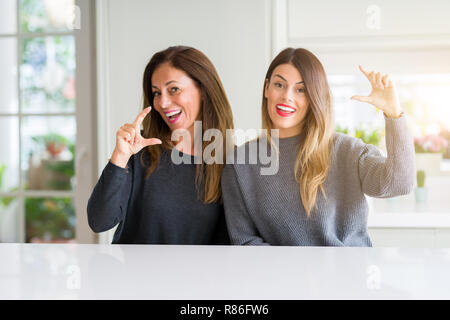 smiling blonde woman with little daughter buying various cereals in ...