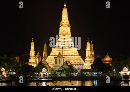 Wat Arun Ratchawararam at night illuminated by bright colored ...