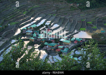 A cluster of traditional houses forming the remote village of Batad ...
