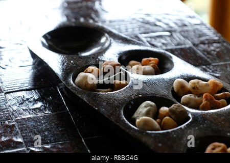 A Philippine mancala strategy board games named Sungka which involves ...