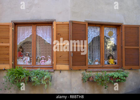 windows with dolls on the windowsill Stock Photo - Alamy