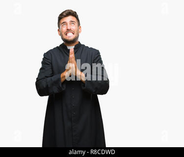 A priest praying over young people at the conclusion of the Mladifest ...