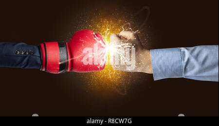 Two hands fighting with orange dust, spark, glow and smoke concept ...