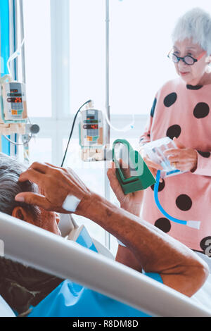 Elderly patients relax in hospital bed Stock Photo - Alamy
