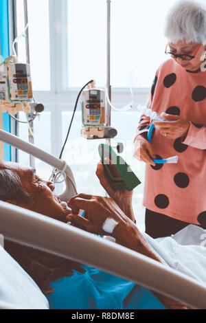 Elderly patients relax in hospital bed Stock Photo - Alamy