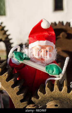 Santa in the cogwheels of consumerism, a concept Stock Photo - Alamy