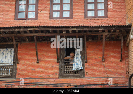 Man in the window of a Newari home, Boudhanath, Kathmandu, Nepal Stock ...