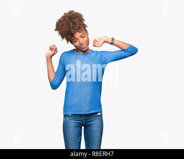 Young beautiful hispanic woman waking up stretching arms at bedroom ...