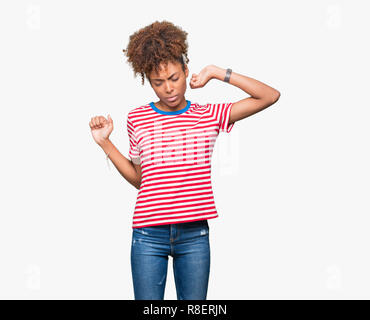 Young beautiful hispanic woman waking up stretching arms at bedroom ...
