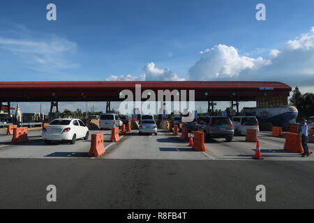 Cars pass through a tollbooth station in the North Luzon Expressway ...