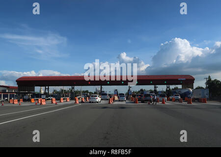 Cars pass through a tollbooth station in the North Luzon Expressway ...