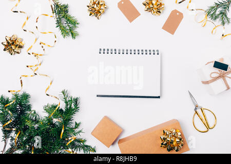 Christmas composition of open blank notepad, coffee cup, scarf and fir ...