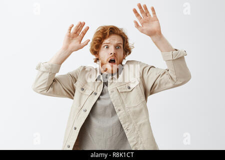 Scared and panicking young worried redhead teenage girl having ...