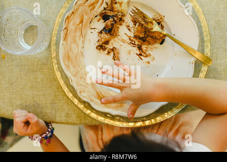 Elegant dish soiled and finished with child's hands finishing eating ...