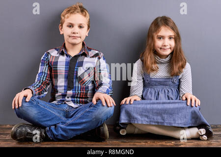 Portrait of kids with crossed legs. Portrait of little sister and ...