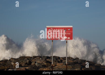 "Danger Restricted Area Keep Out" sign posted on the shoreline of the ...