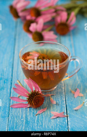 Cup of echinacea tea on blue wooden table Stock Photo - Alamy