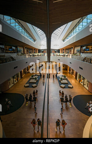 Shoppers and tourists enjoy the view inside the Oculus and stores in ...