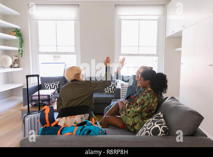 Young women in the sofa listening to music Stock Photo - Alamy